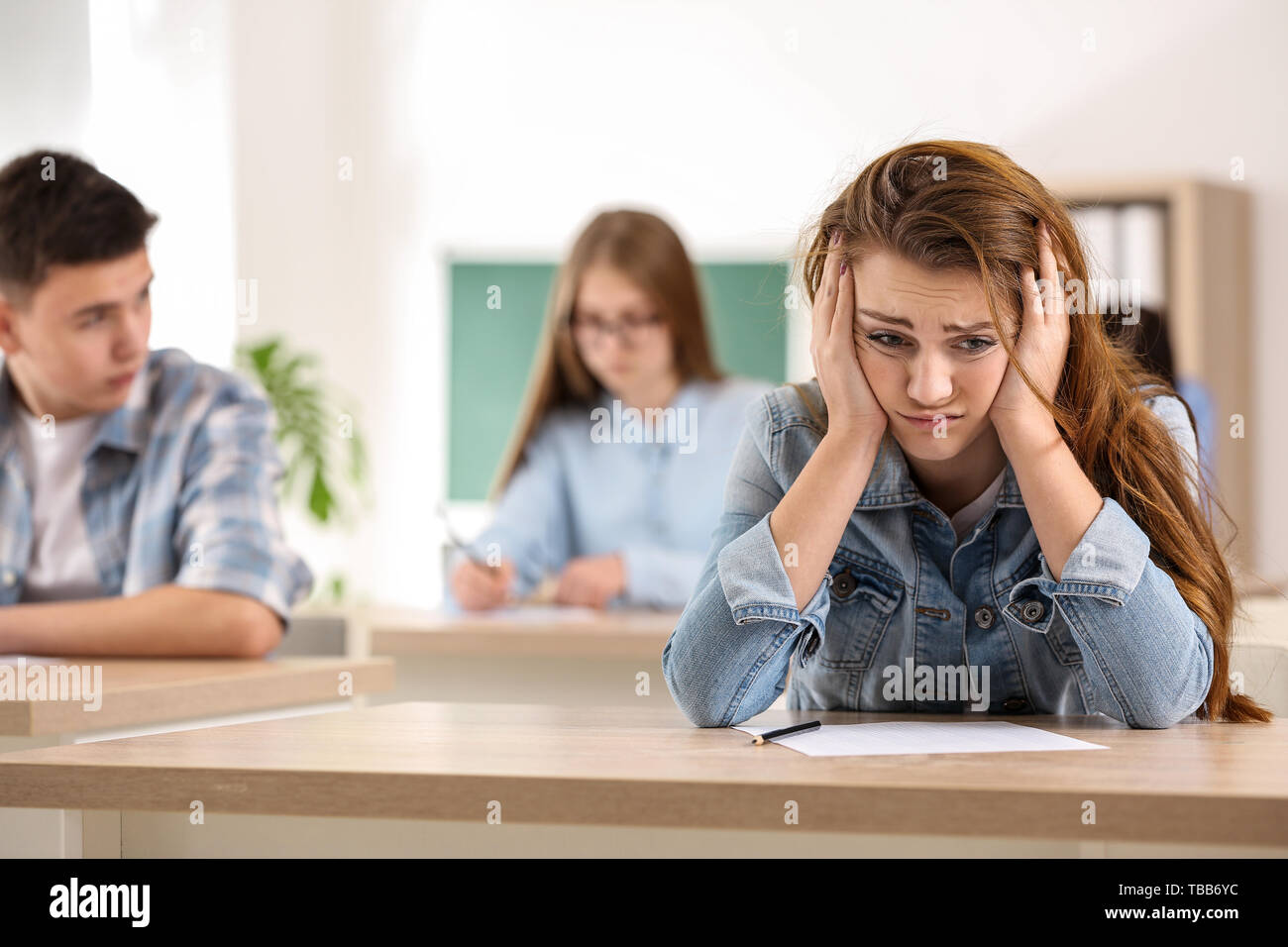 Stressed girl passing school test in classroom Stock Photo - Alamy