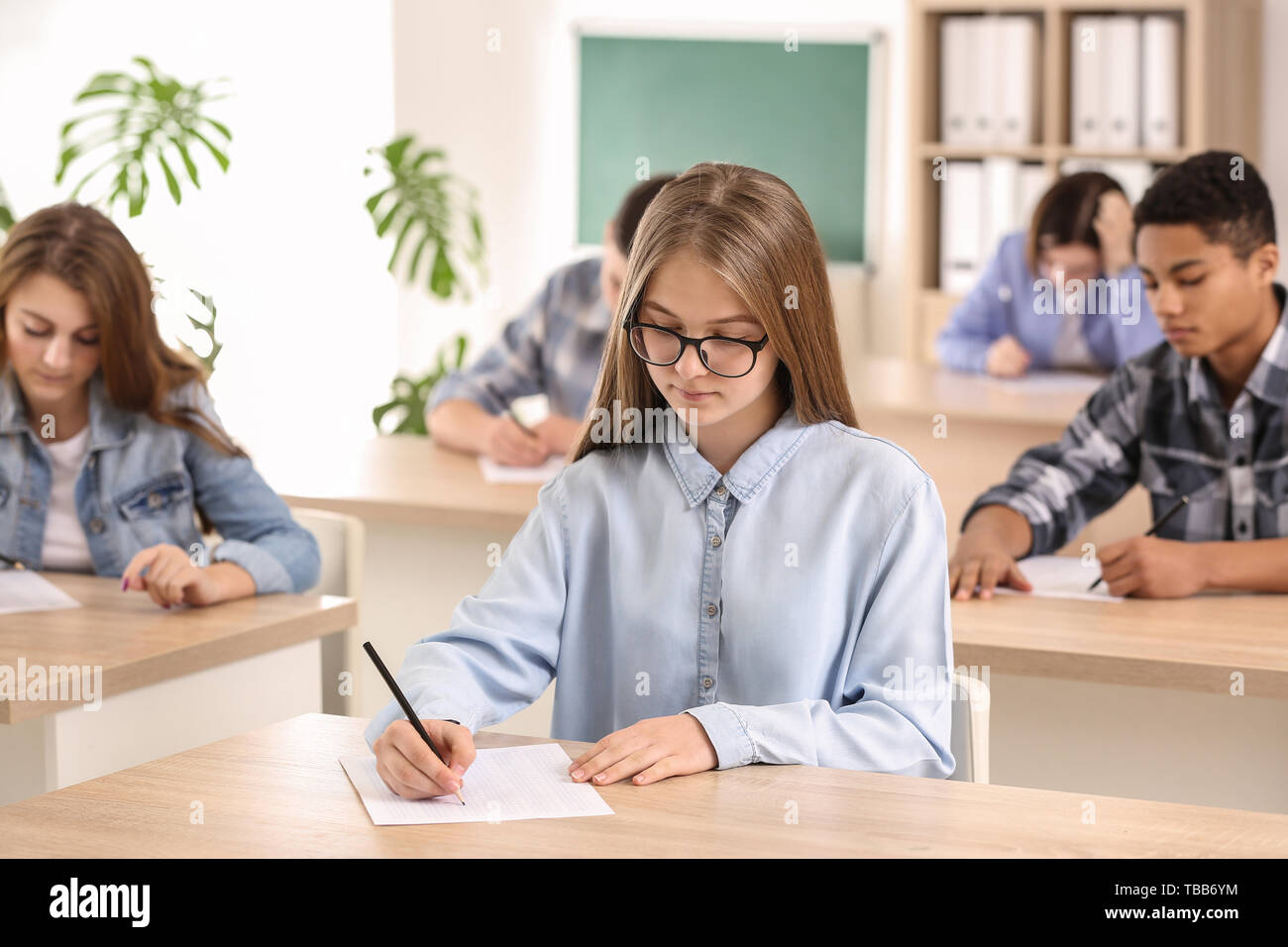 Pupils passing school test in classroom Stock Photo - Alamy