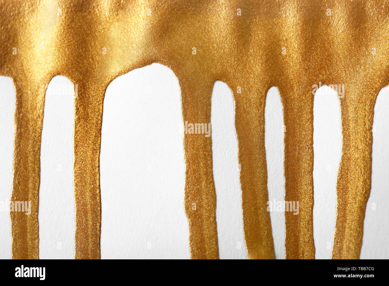 Streaks of golden paint on white background Stock Photo - Alamy