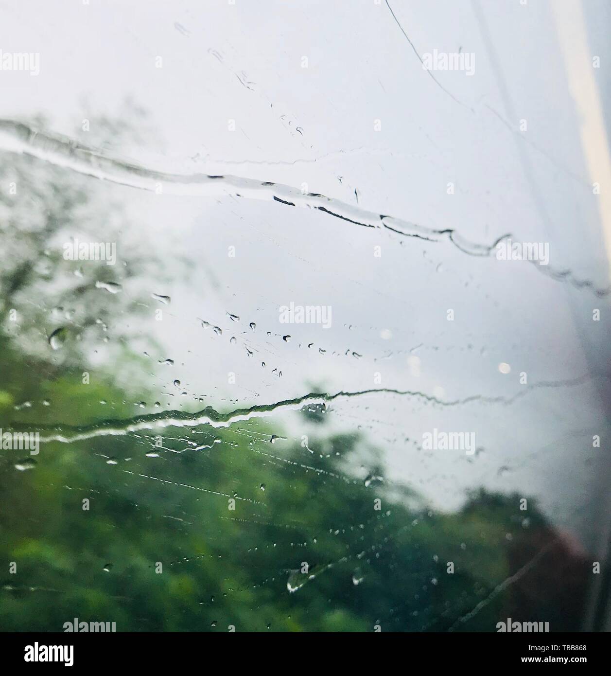 It was raining outside, sitting on the train, looking at the window ...