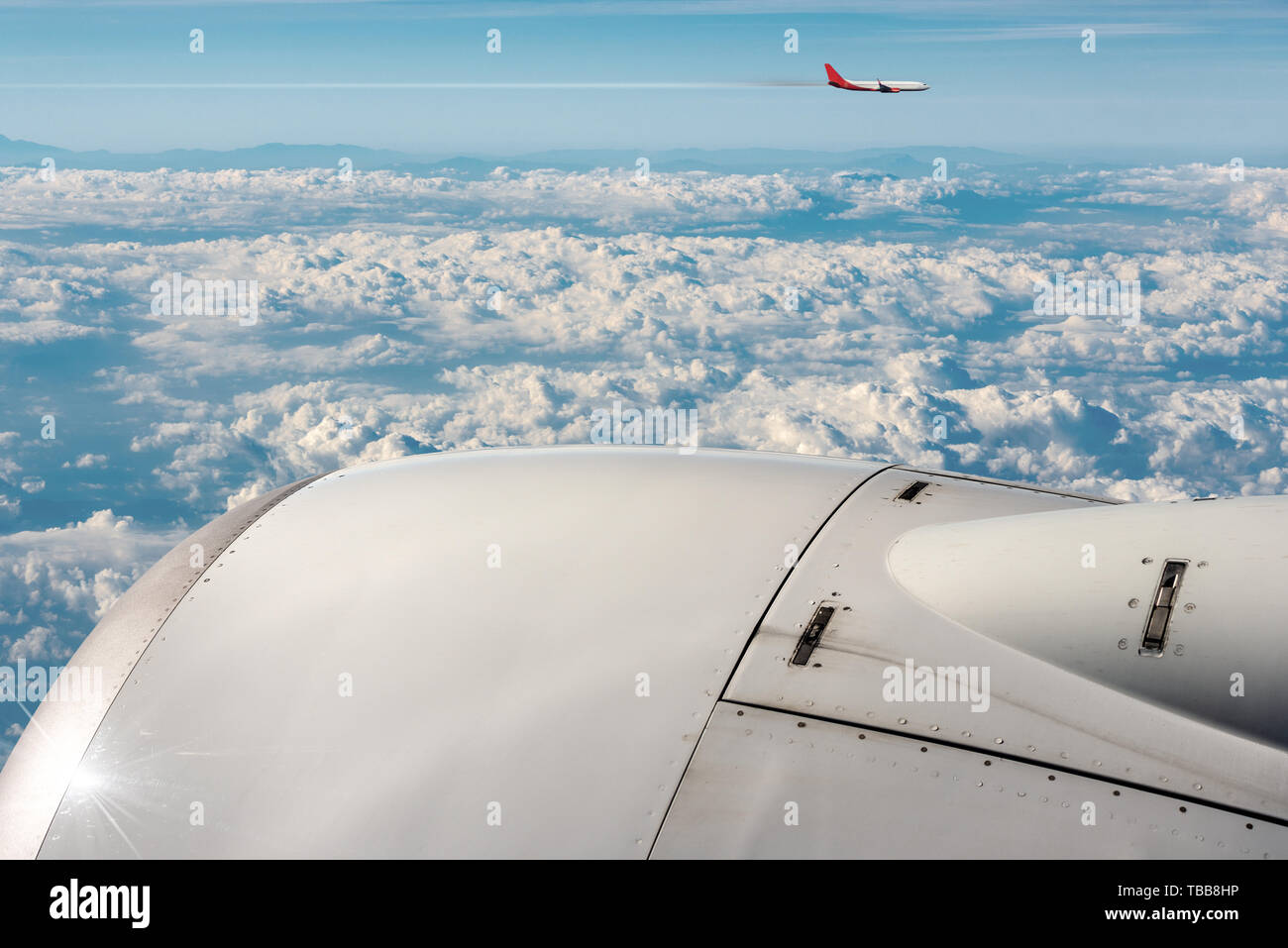 Two commercial airplanes (engine and plane) while flying above the ...