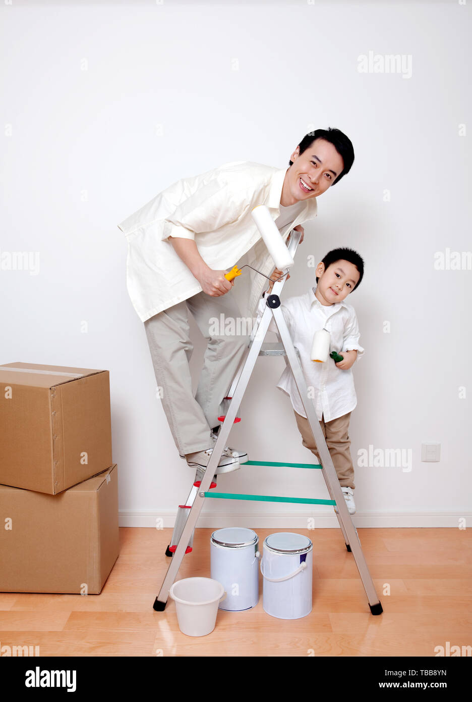Kids help decorate the new house Stock Photo - Alamy
