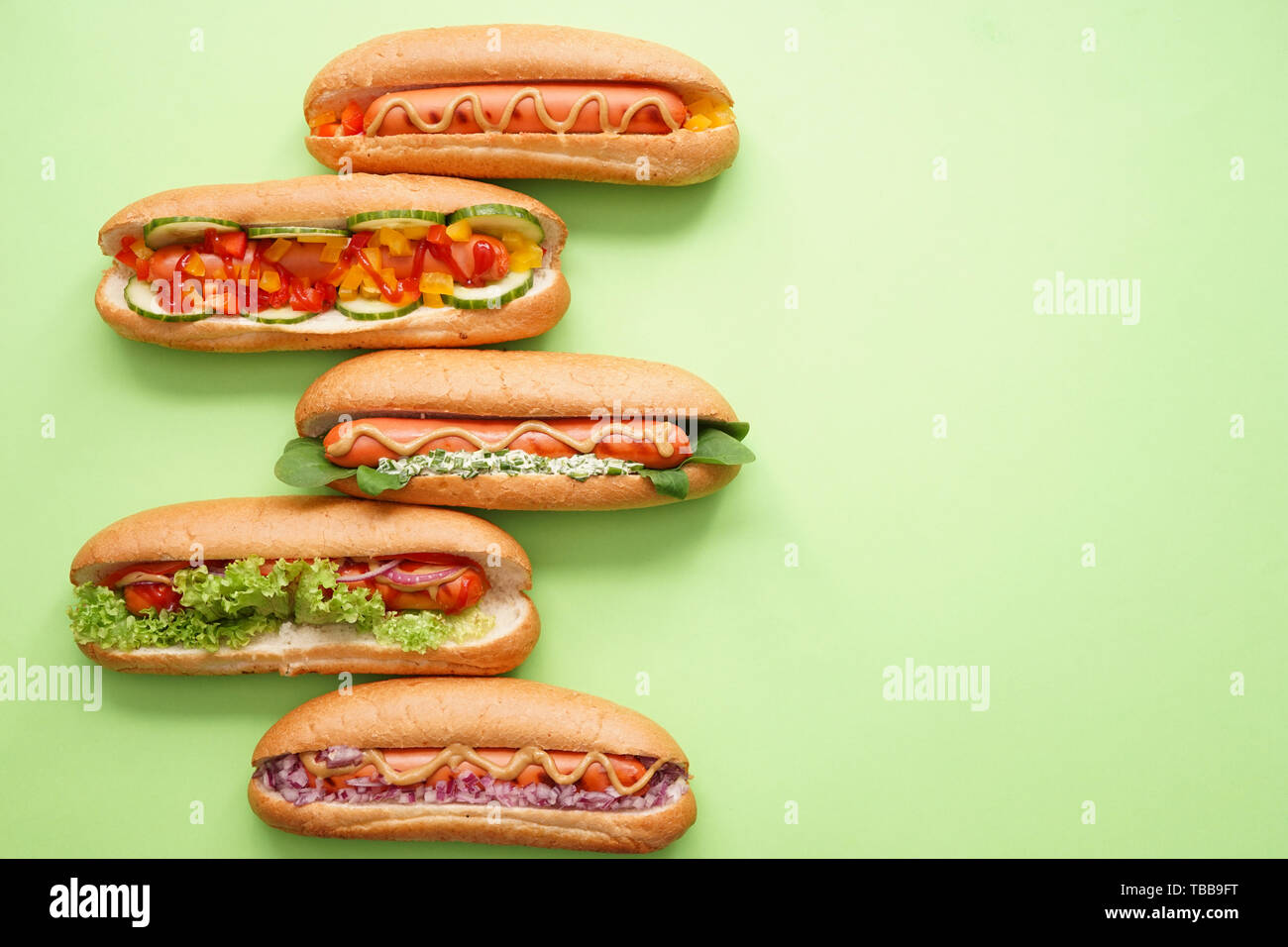 Tasty hot dogs on color background Stock Photo - Alamy