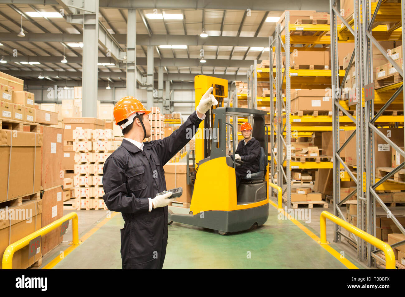 Logistics personnel load and unload cargo at the warehouse Stock Photo ...