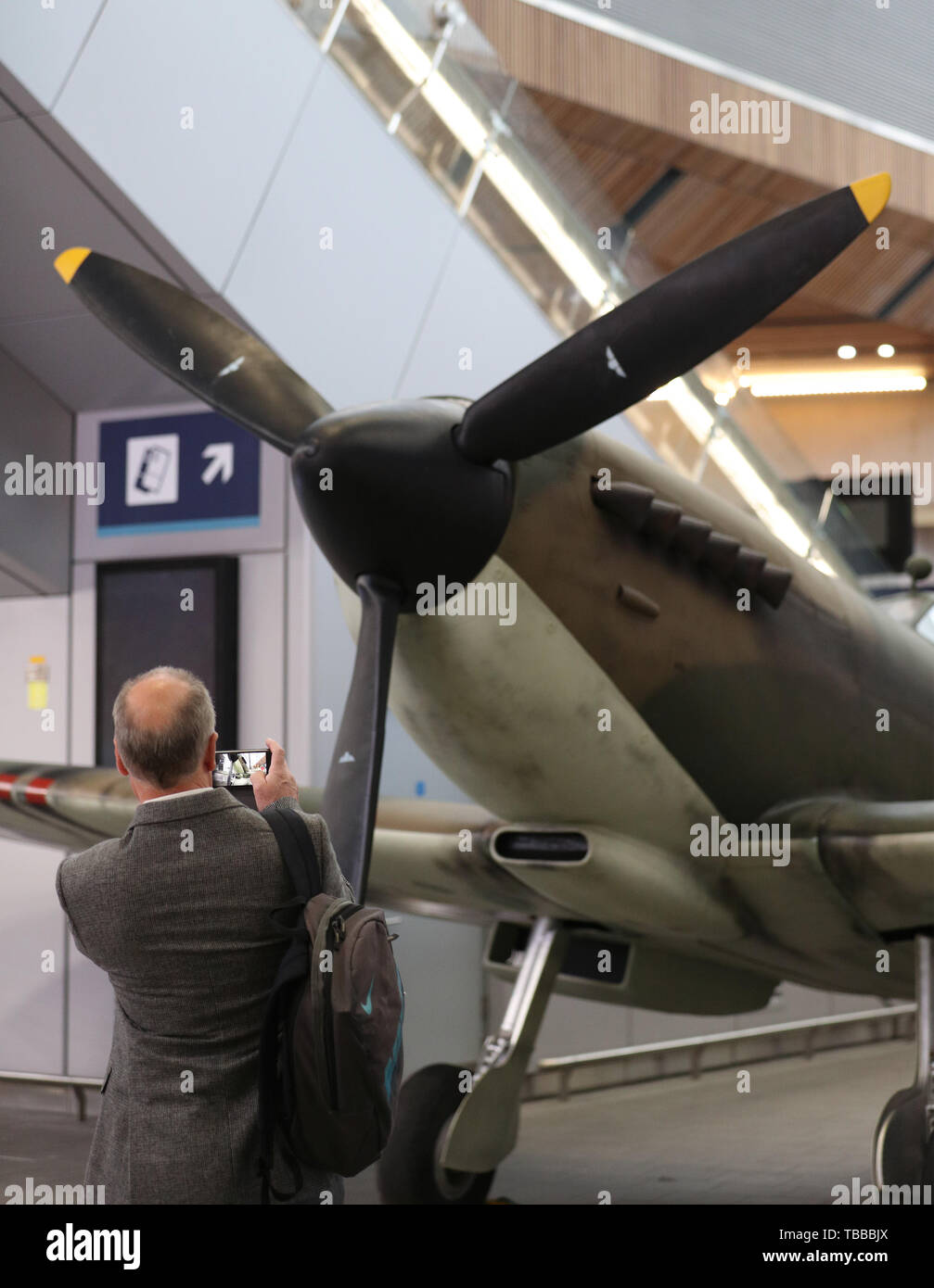 A man takes a picture of the replica Supermarine Spitfire sitting on ...