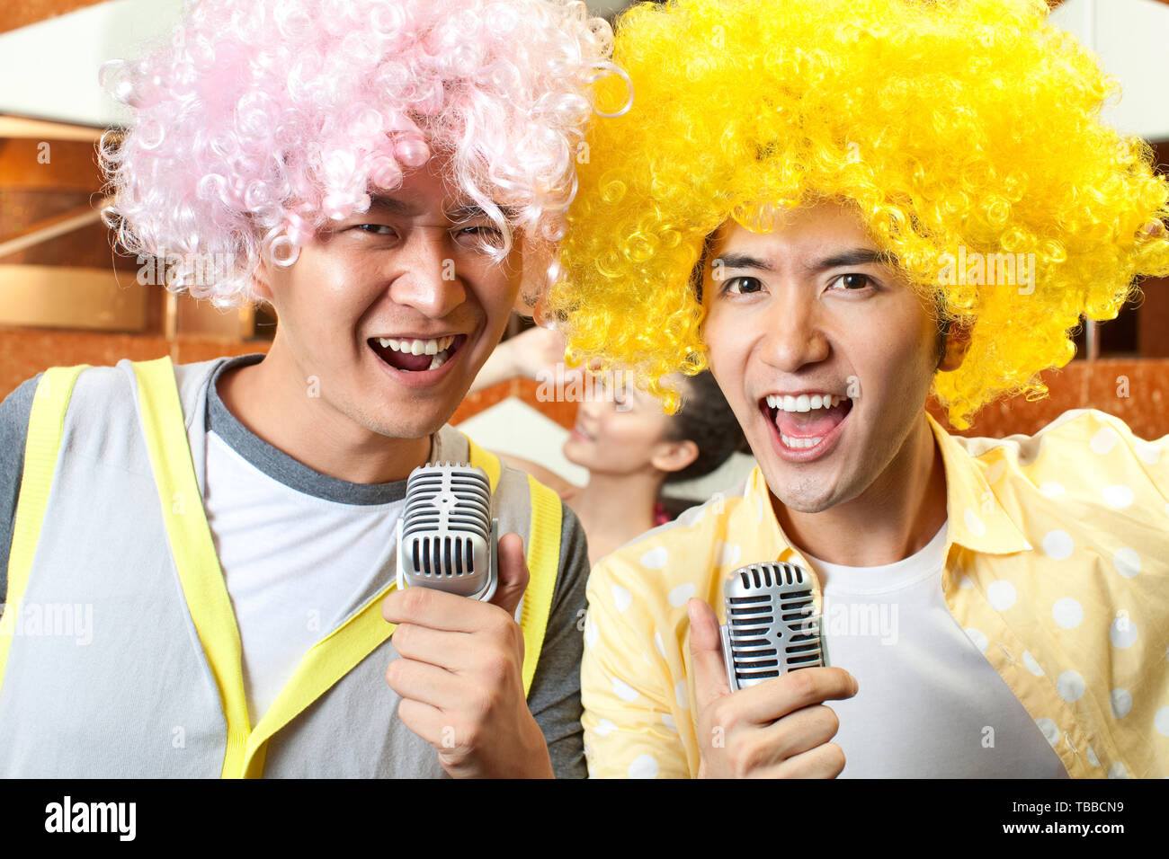 Three friends sing at KTV party Stock Photo - Alamy