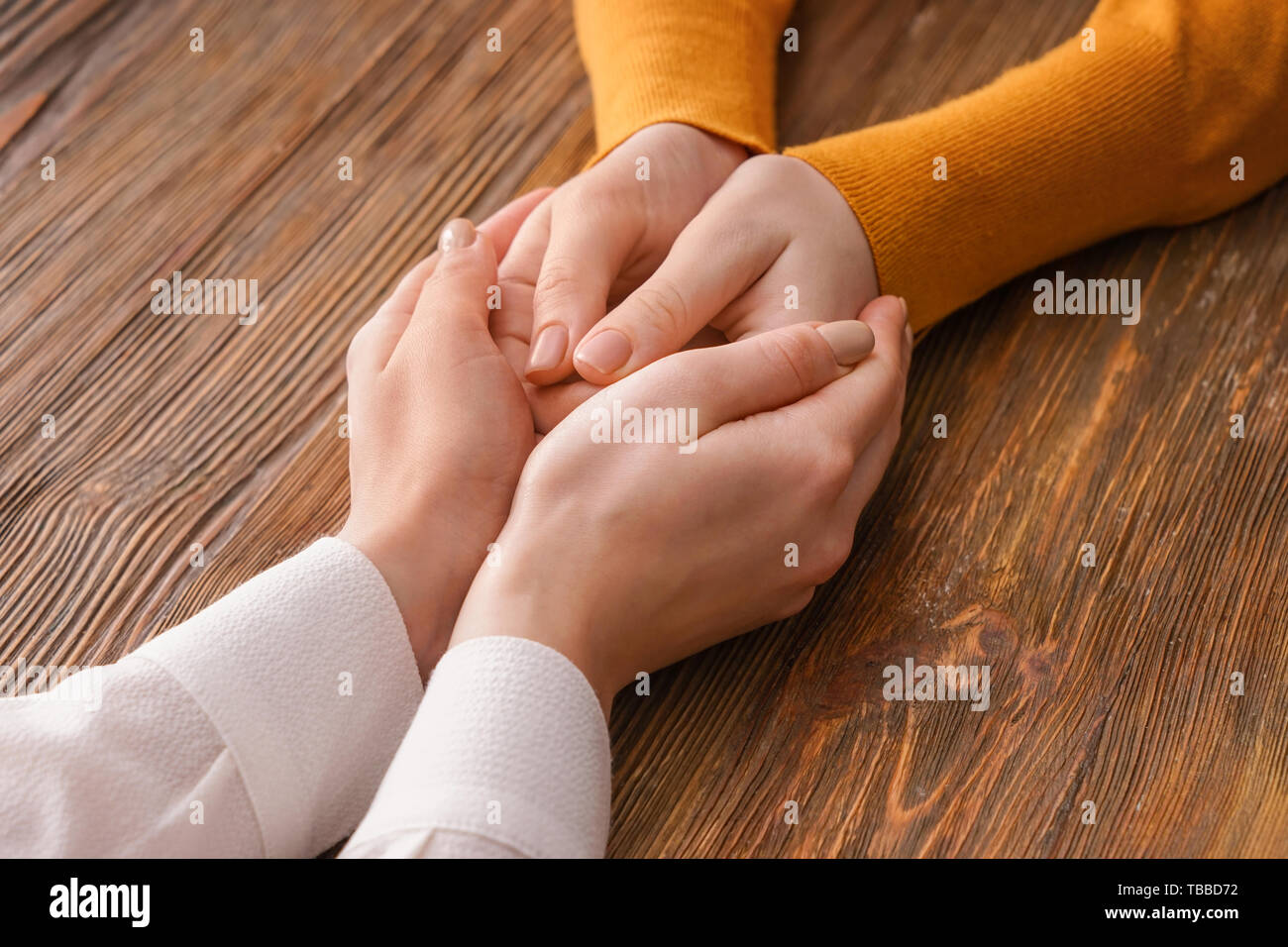 Comforting hand friends women hi-res stock photography and images - Alamy
