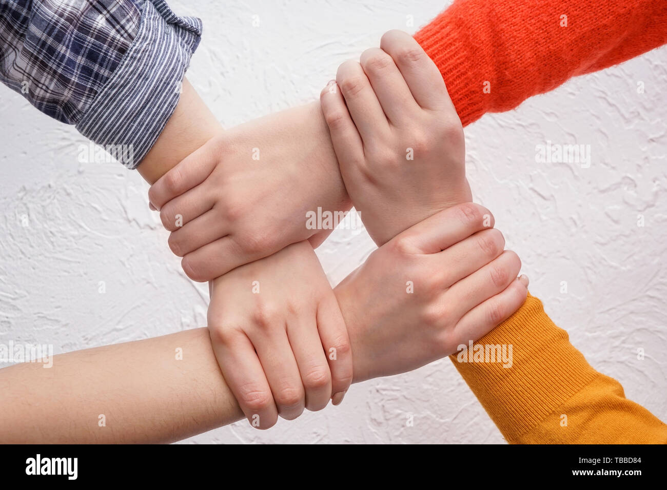 People putting hands together on light background Stock Photo - Alamy