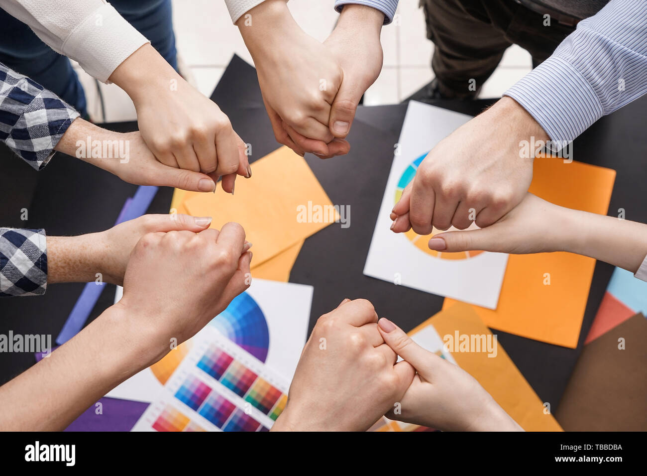 Group of people holding hands in office. Concept of unity Stock Photo ...