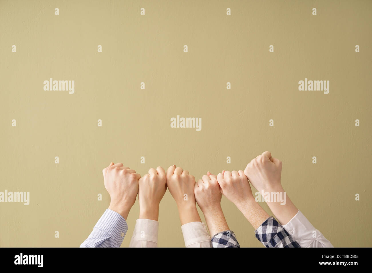 Group of people holding hands together on color background. Concept of ...