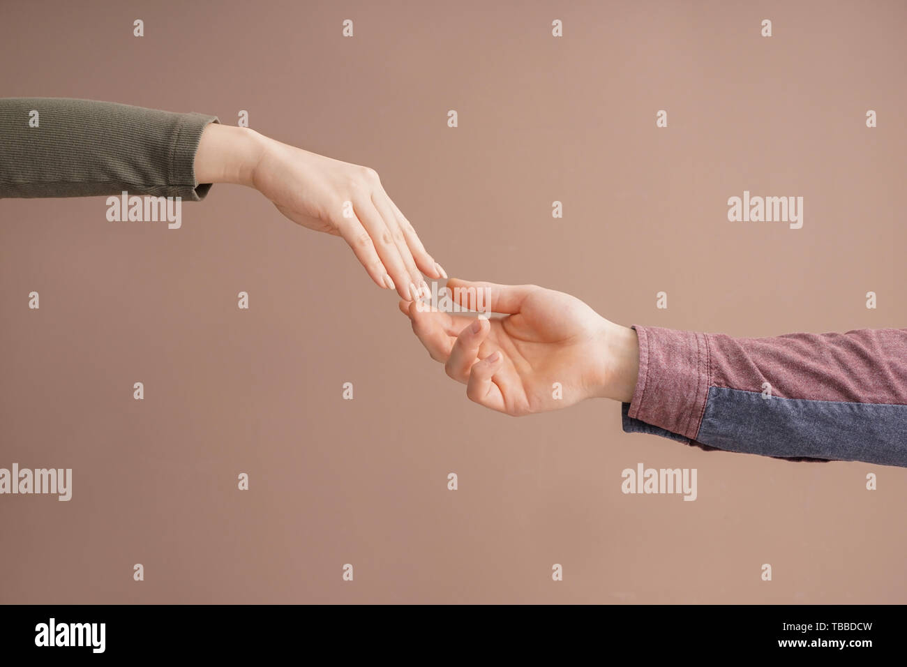 Man and woman giving each other hands on color background. Concept of ...