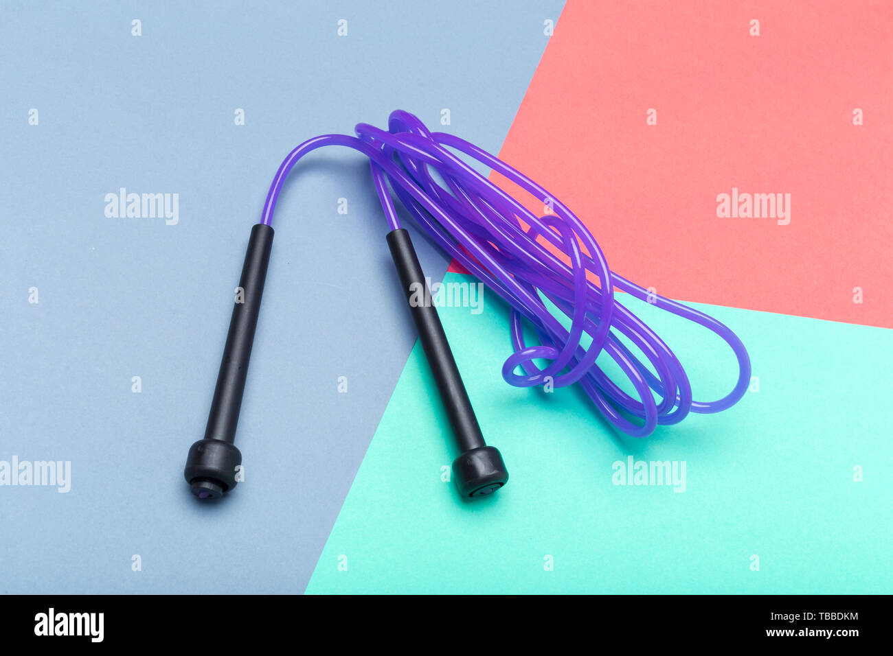Green rubber jumping rope with blue handles top view Stock Photo - Alamy