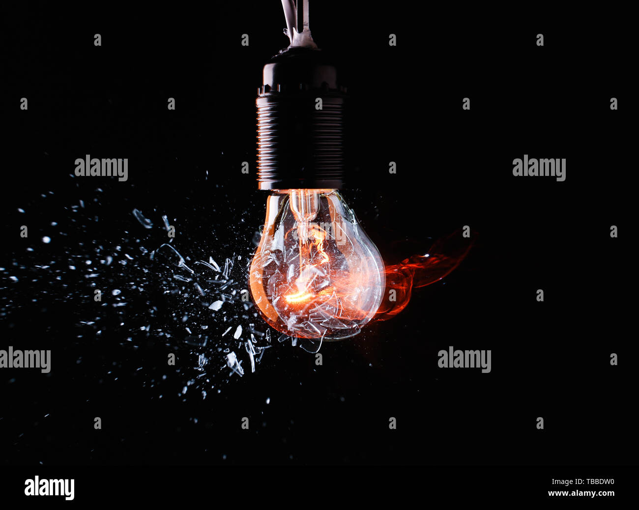 Breaking of light bulb on dark background Stock Photo - Alamy