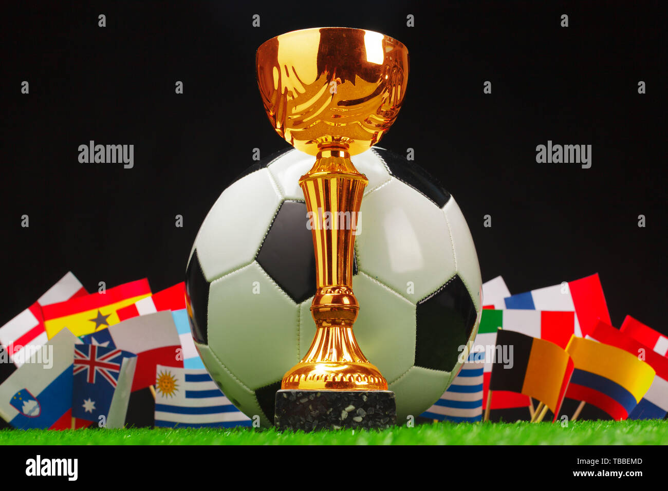Football cup with football ball on grass Stock Photo - Alamy