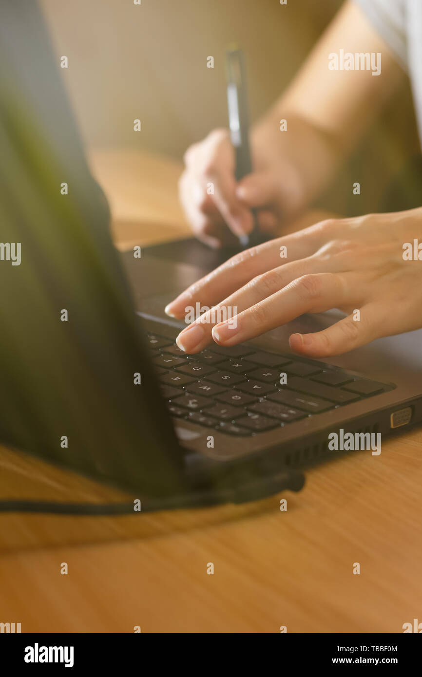 Illustrator using a graphics tablet. Woman's retoucher's hands using ...