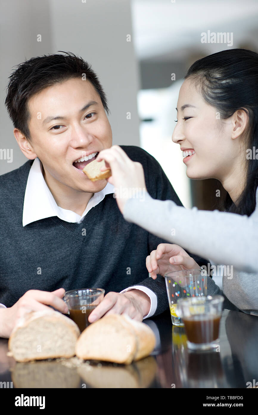 Wife feeding husband dining table hi-res stock photography and images - Alamy