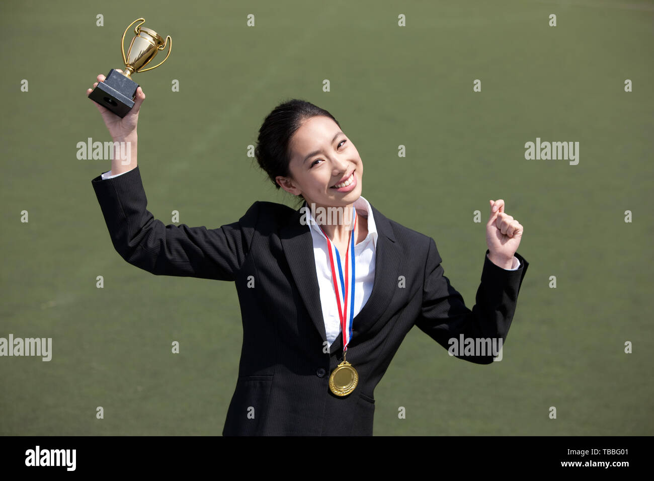 Woman hand raised gold medal hi-res stock photography and images - Alamy