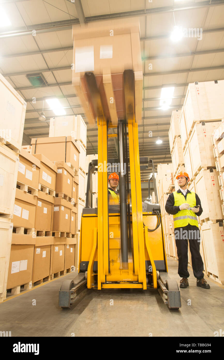 Logistics personnel load and unload cargo at the warehouse Stock Photo ...
