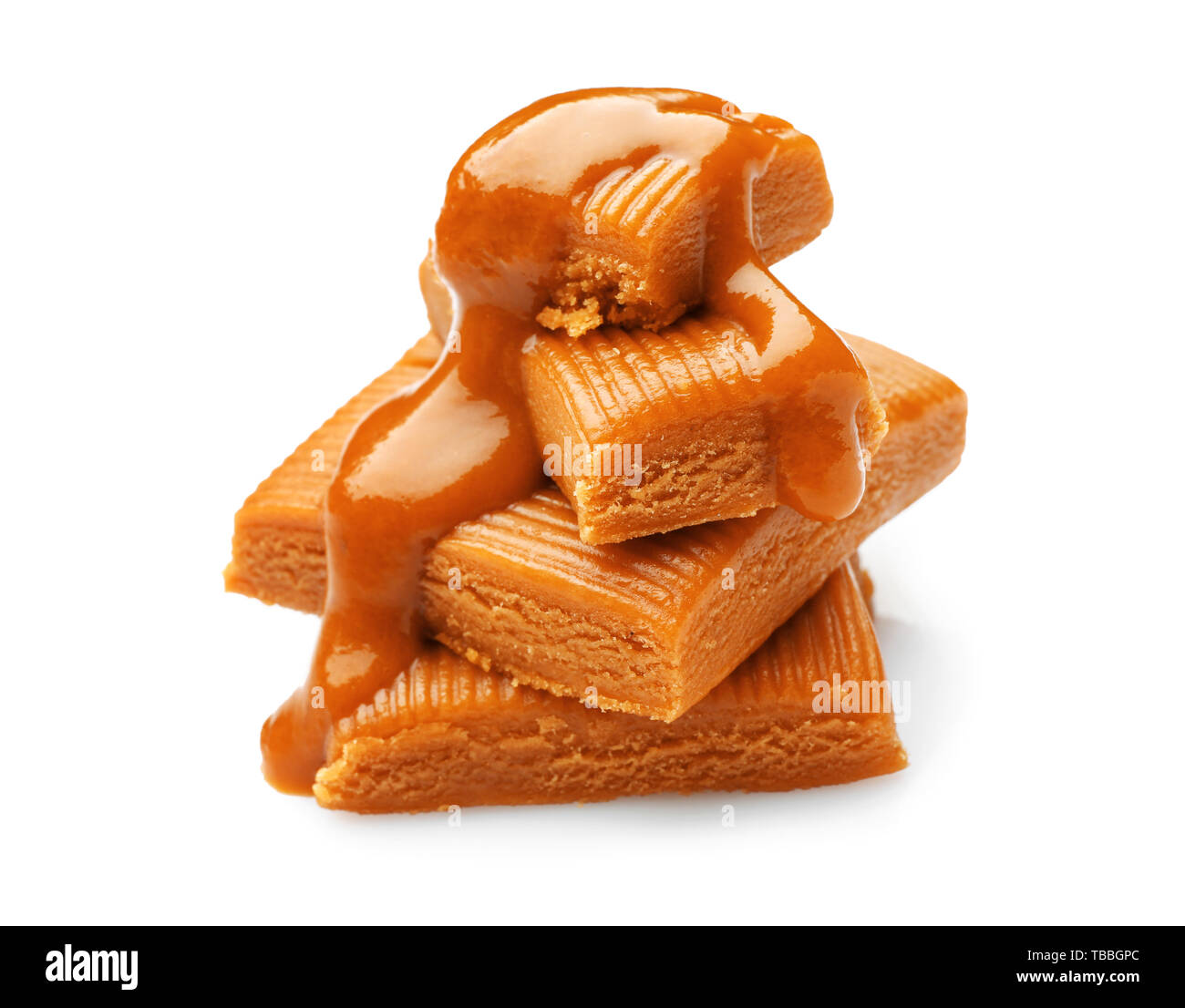 Tasty sweet caramel on white background Stock Photo - Alamy