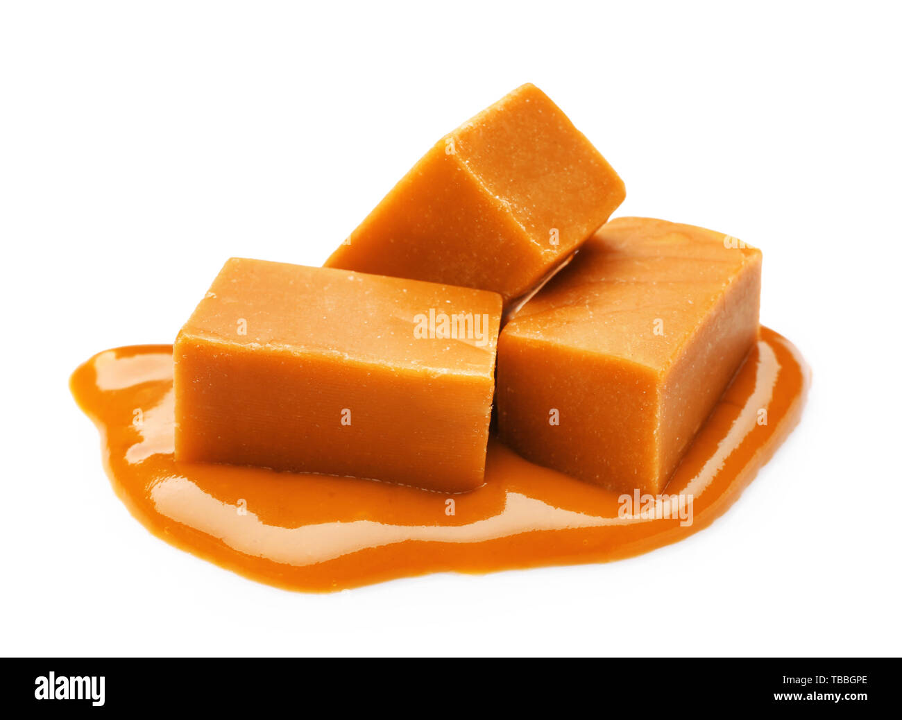 Tasty sweet caramel on white background Stock Photo - Alamy