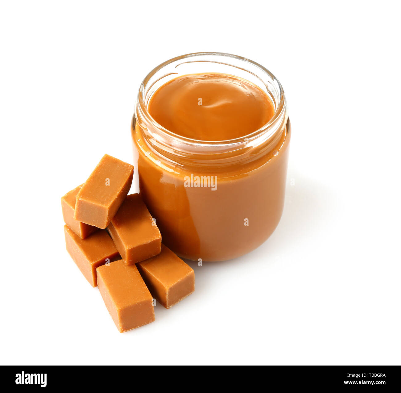Jar with sweet liquid caramel on white background Stock Photo - Alamy