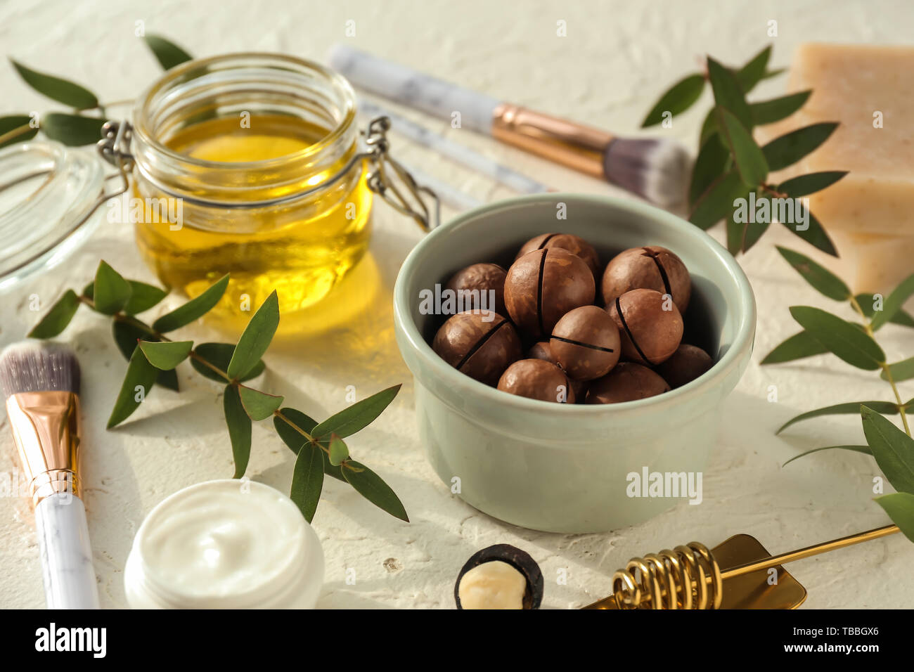 Macadamia nuts with cosmetic products on white table Stock Photo - Alamy