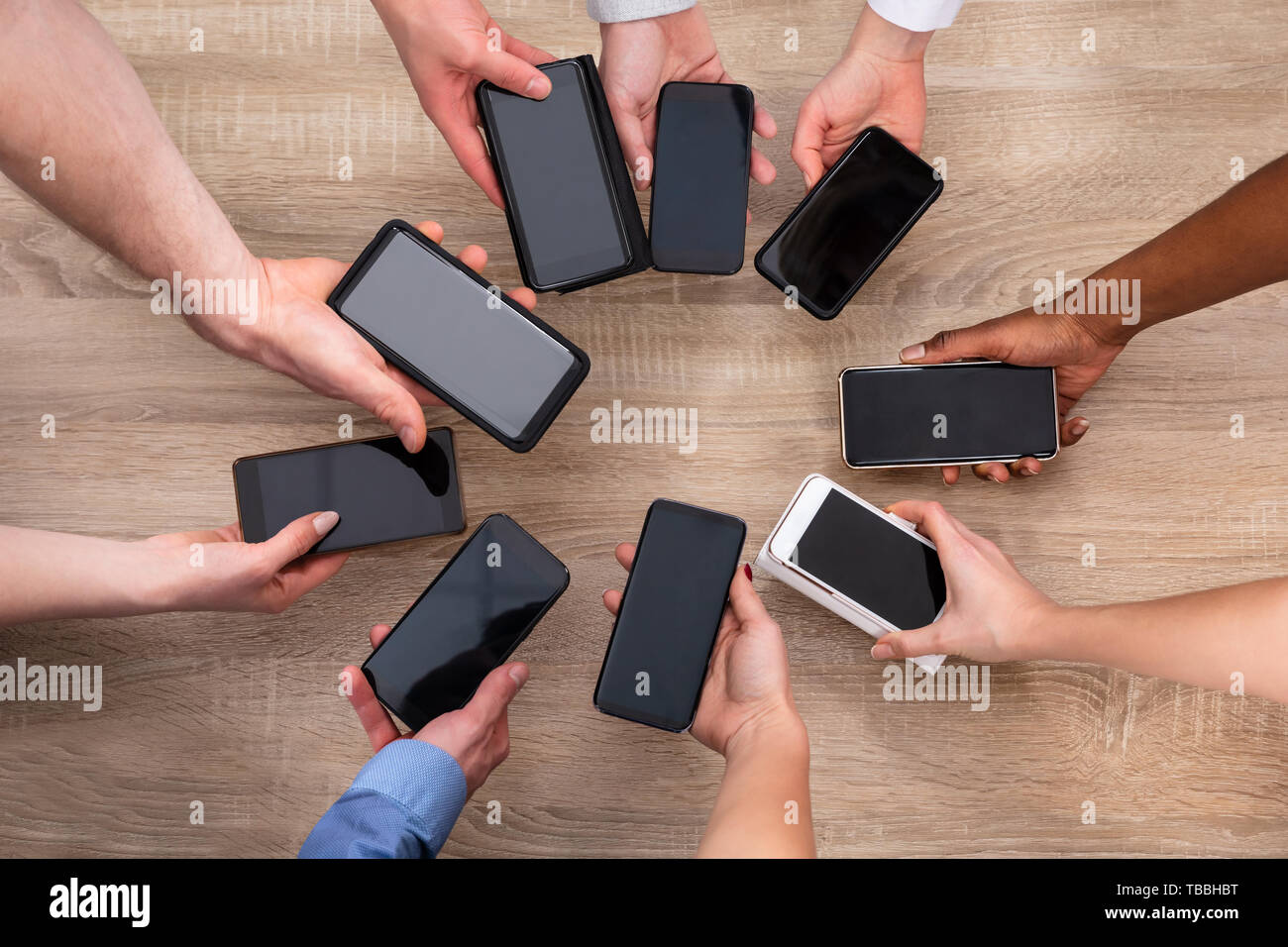 Top View Of People's Hand Showing Blank Display Mobile Phone Above ...