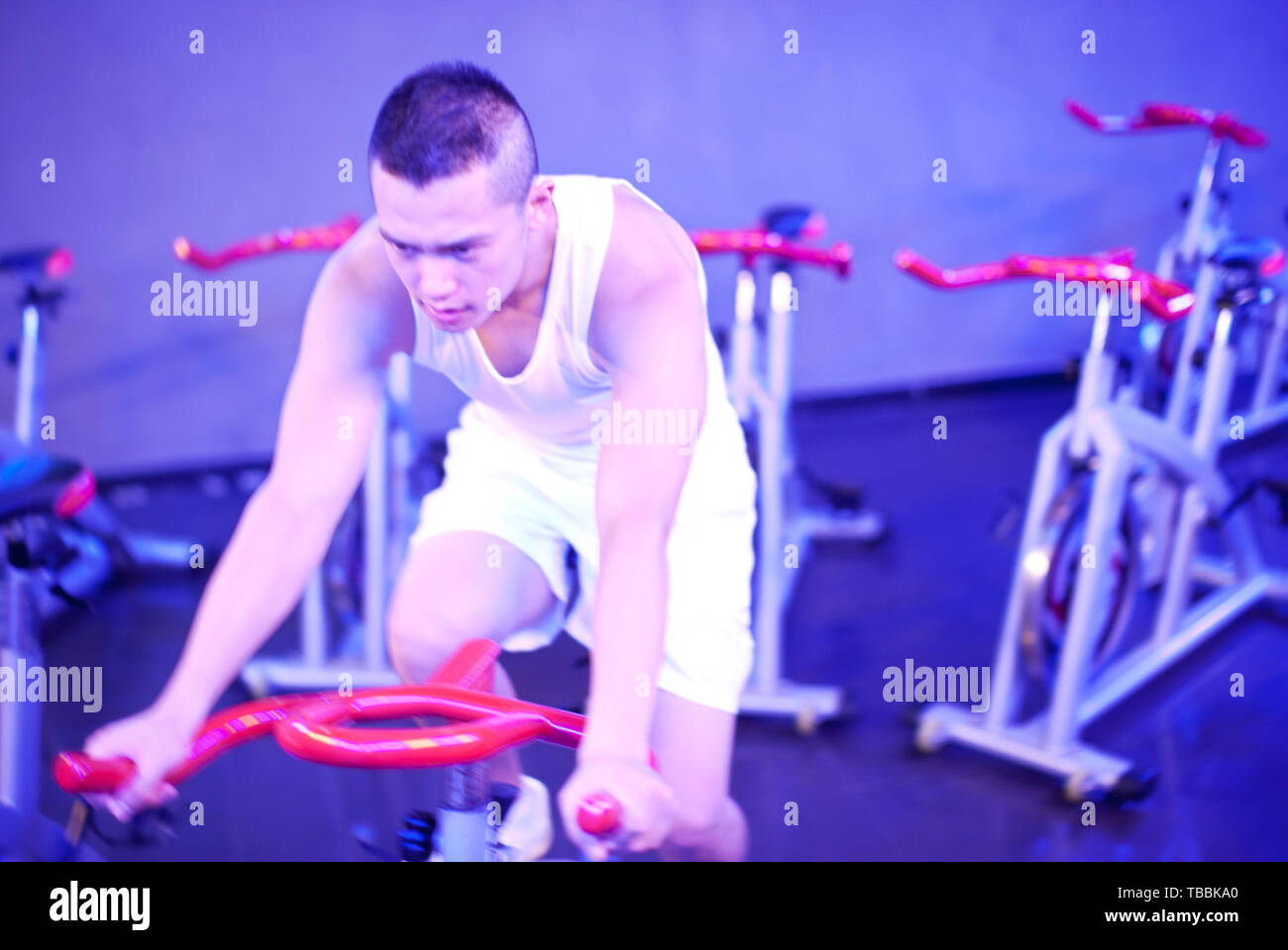 Riding a gym bike at the gym Stock Photo - Alamy
