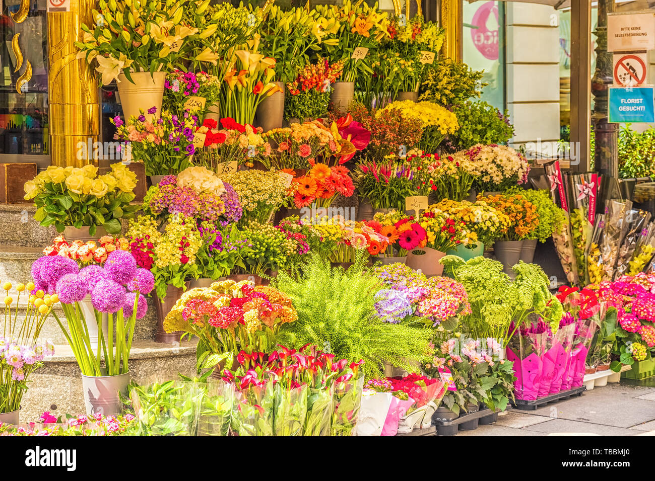 Bouquets of colorful flowers at the entry of flower shop Stock Photo ...