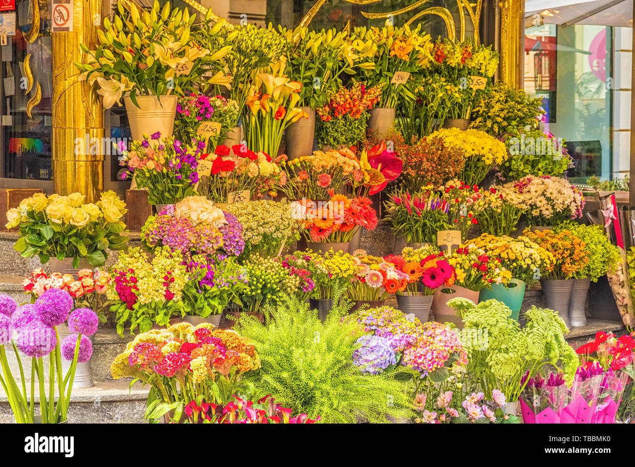Bouquets of colorful flowers at the entry of flower shop Stock Photo ...
