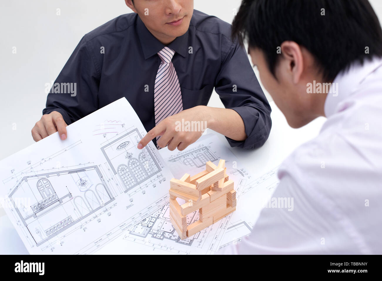 Business people analyzing drawings Stock Photo - Alamy