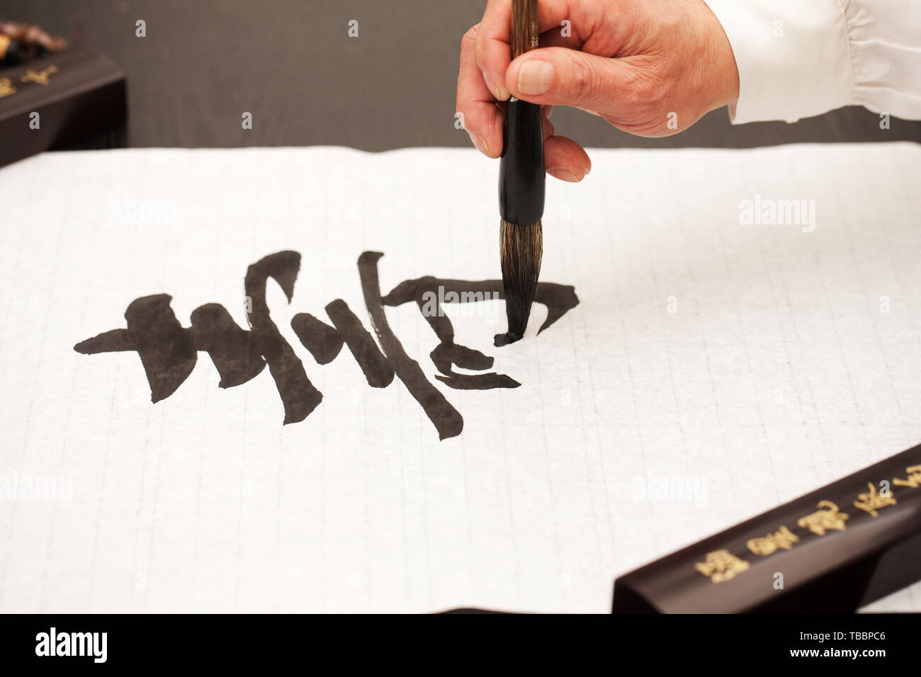 An old man practicing calligraphy Stock Photo - Alamy