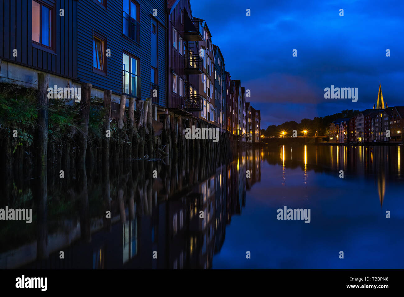 Detail of typical stilt houses on Nidelva River in Trondheim at night ...