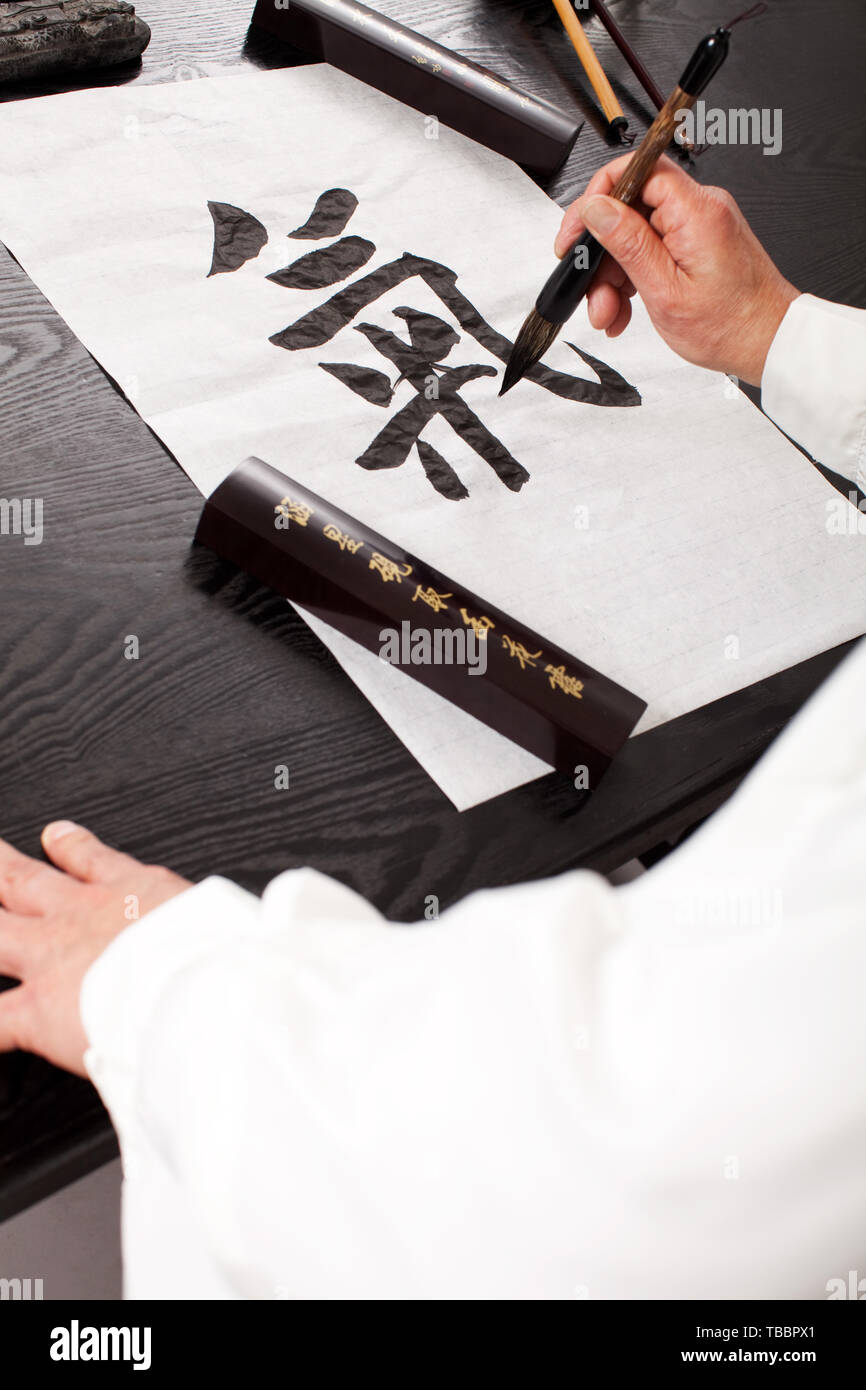 An old man practicing calligraphy Stock Photo - Alamy