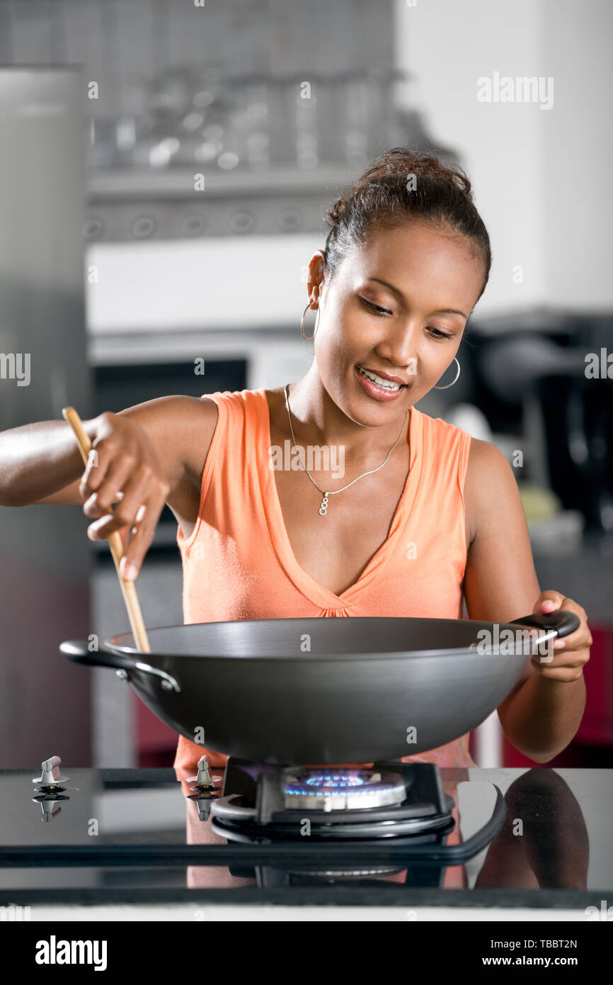 Young woman cooking at home, prepare food in kitchen Stock Photo - Alamy