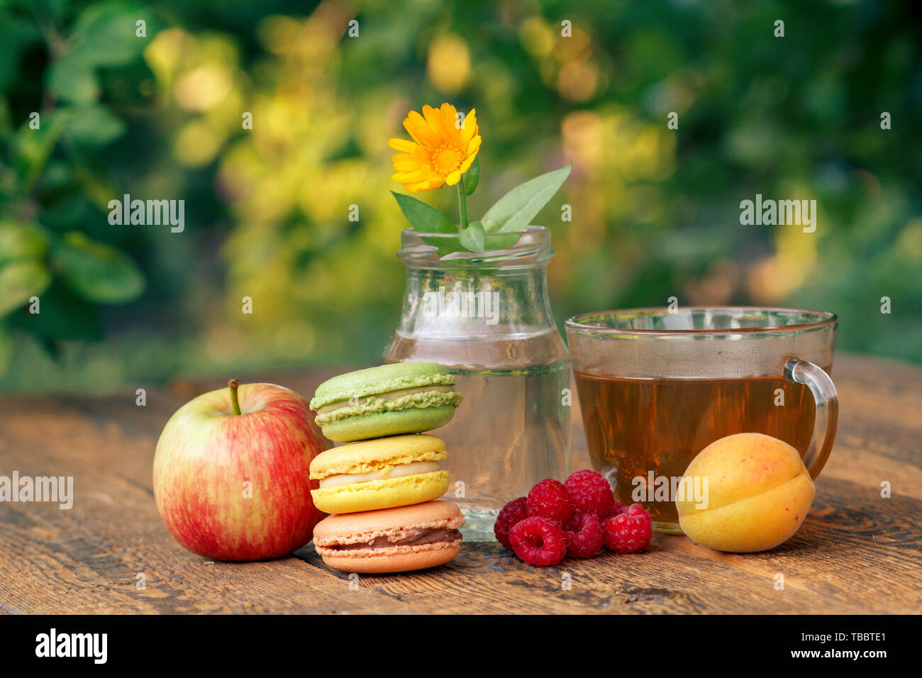 Ripe fruits of apple, apricot and raspberries, calendula flower with a ...