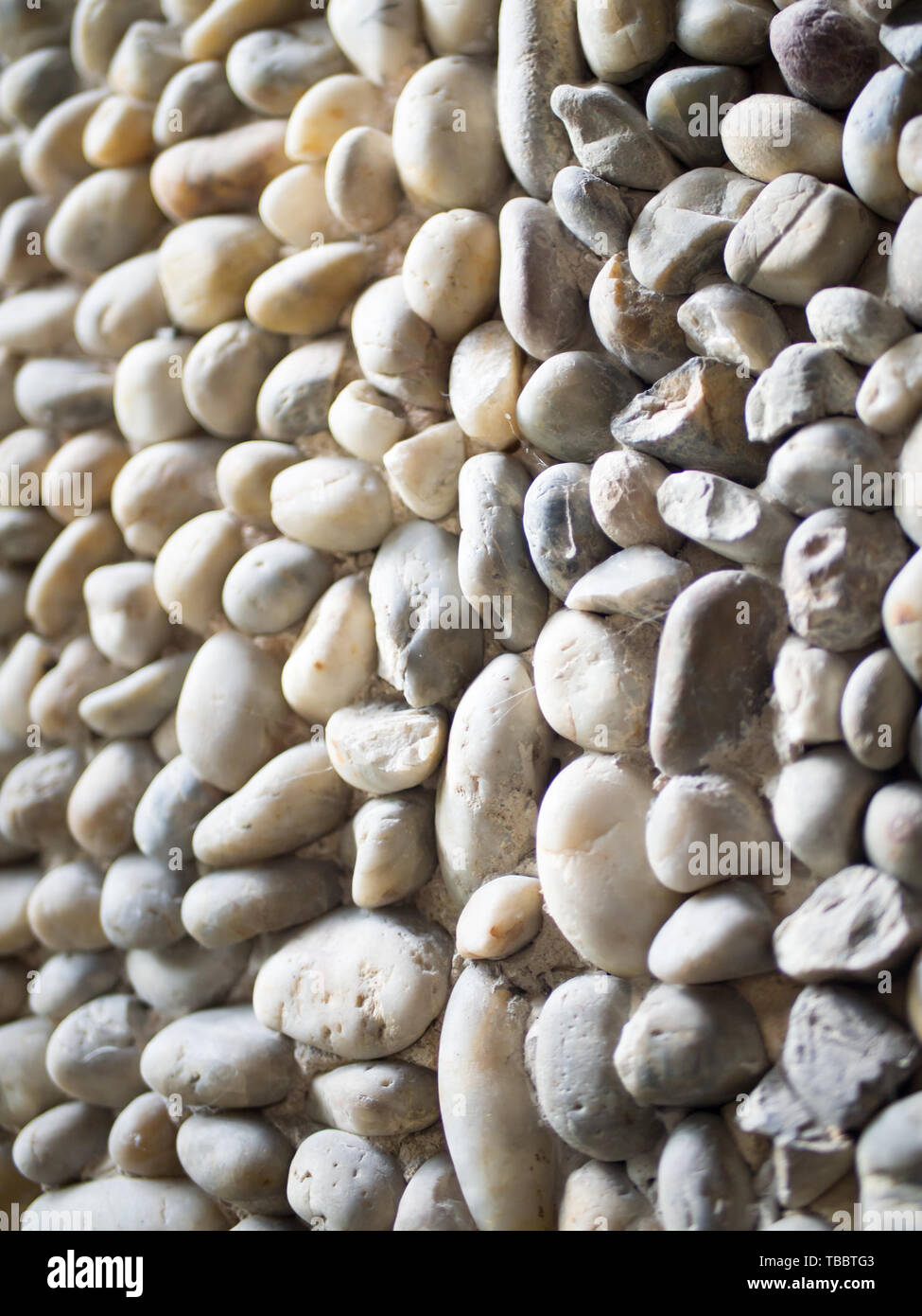 Wall decorated with round natural stones. Stone texture and background ...