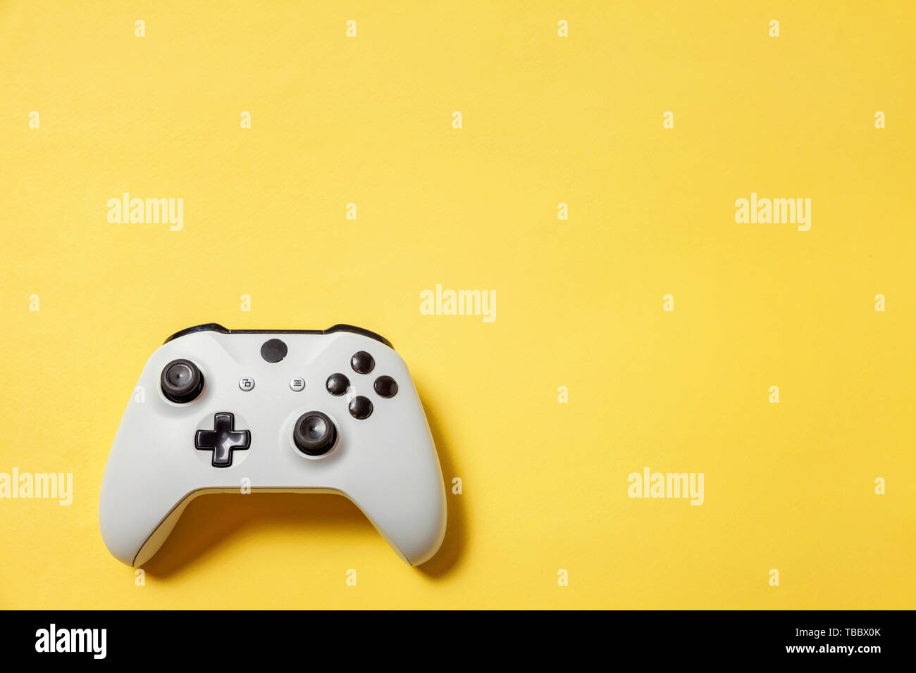 White joystick gamepad, game console on yellow colourful trendy modern ...