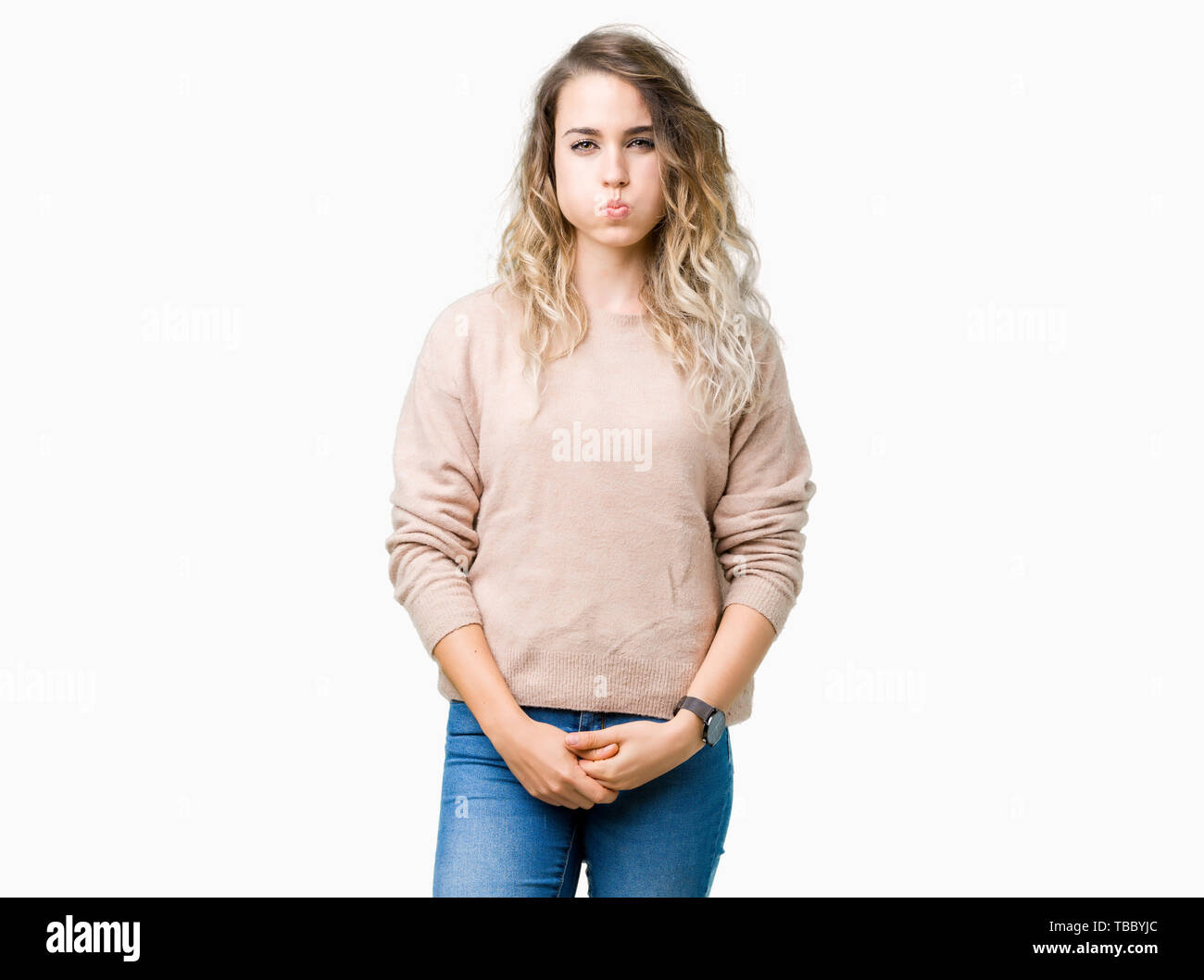 Beautiful young blonde woman wearing sweatershirt over isolated ...