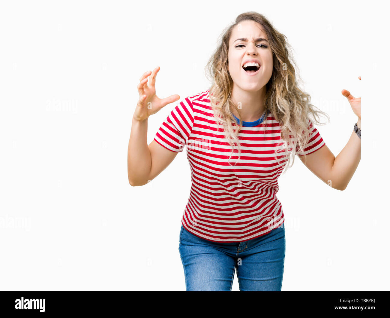 Beautiful young blonde woman over isolated background Shouting ...