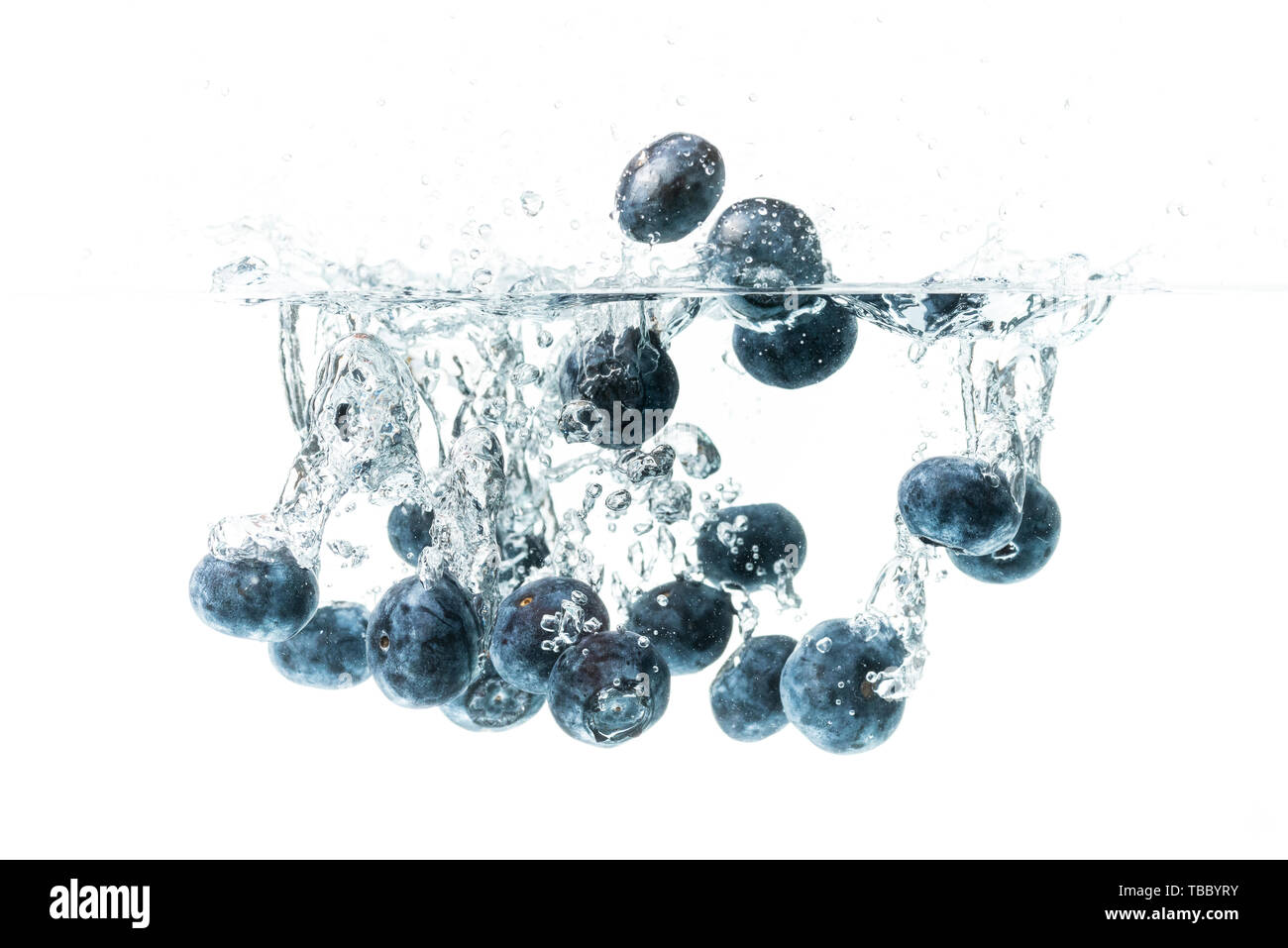 Blueberries sinking underwater with air bubbles isolated on white ...
