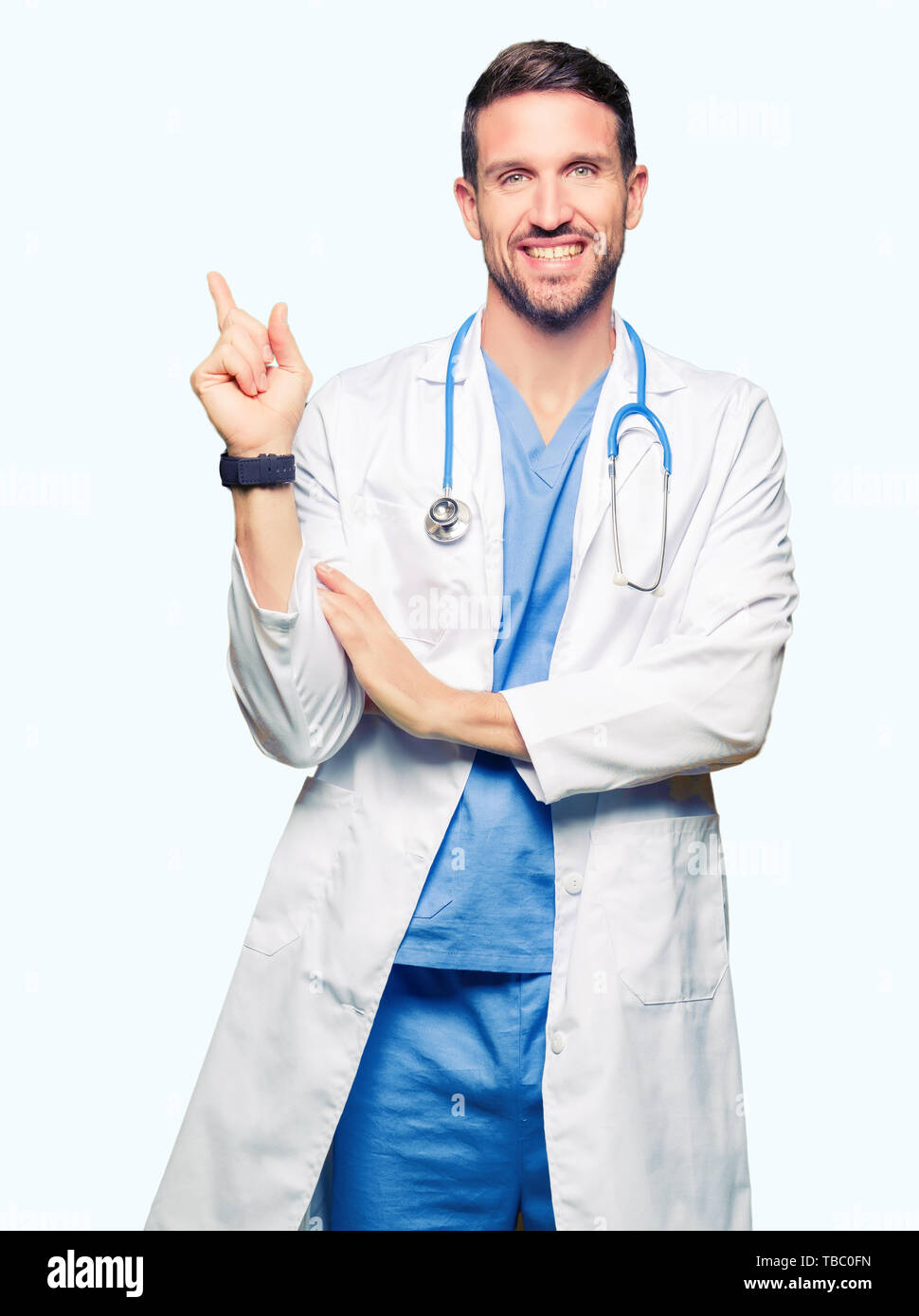 Handsome doctor man wearing medical uniform over isolated background ...