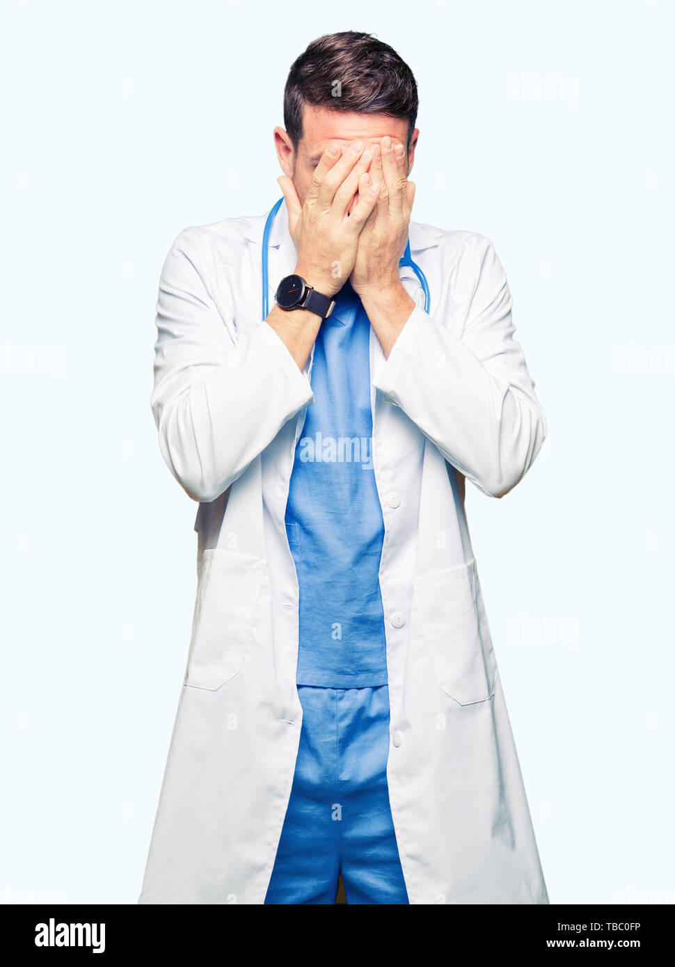 Handsome doctor man wearing medical uniform over isolated background ...