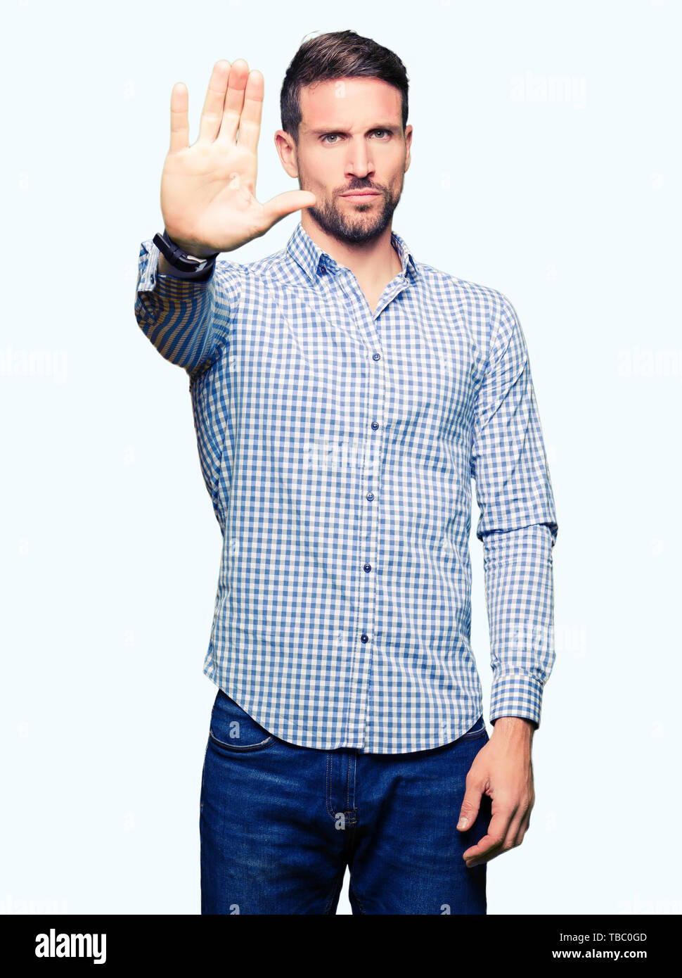 Handsome business man with blue eyes doing stop sing with palm of the ...