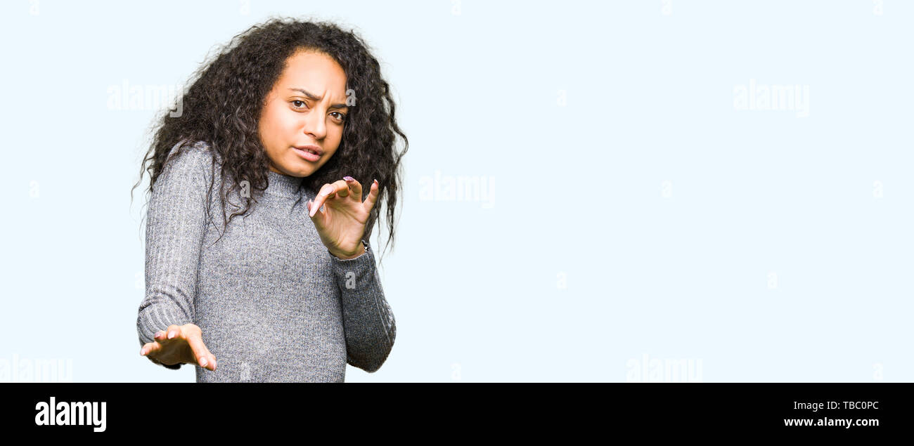 Young beautiful girl with curly hair disgusted expression, displeased ...