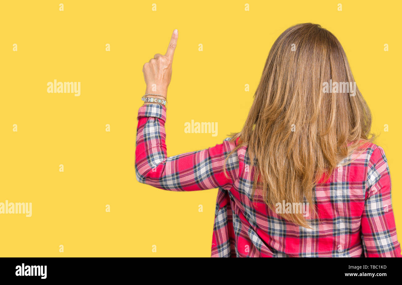 Beautiful middle age woman wearing over isolated background Posing ...