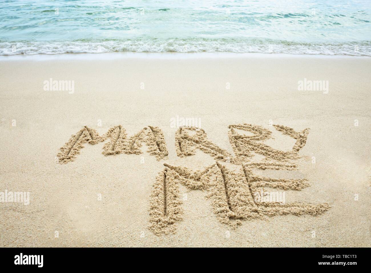 Marry Me Written On Sand With Footprints Near The Sea At Beach Stock ...