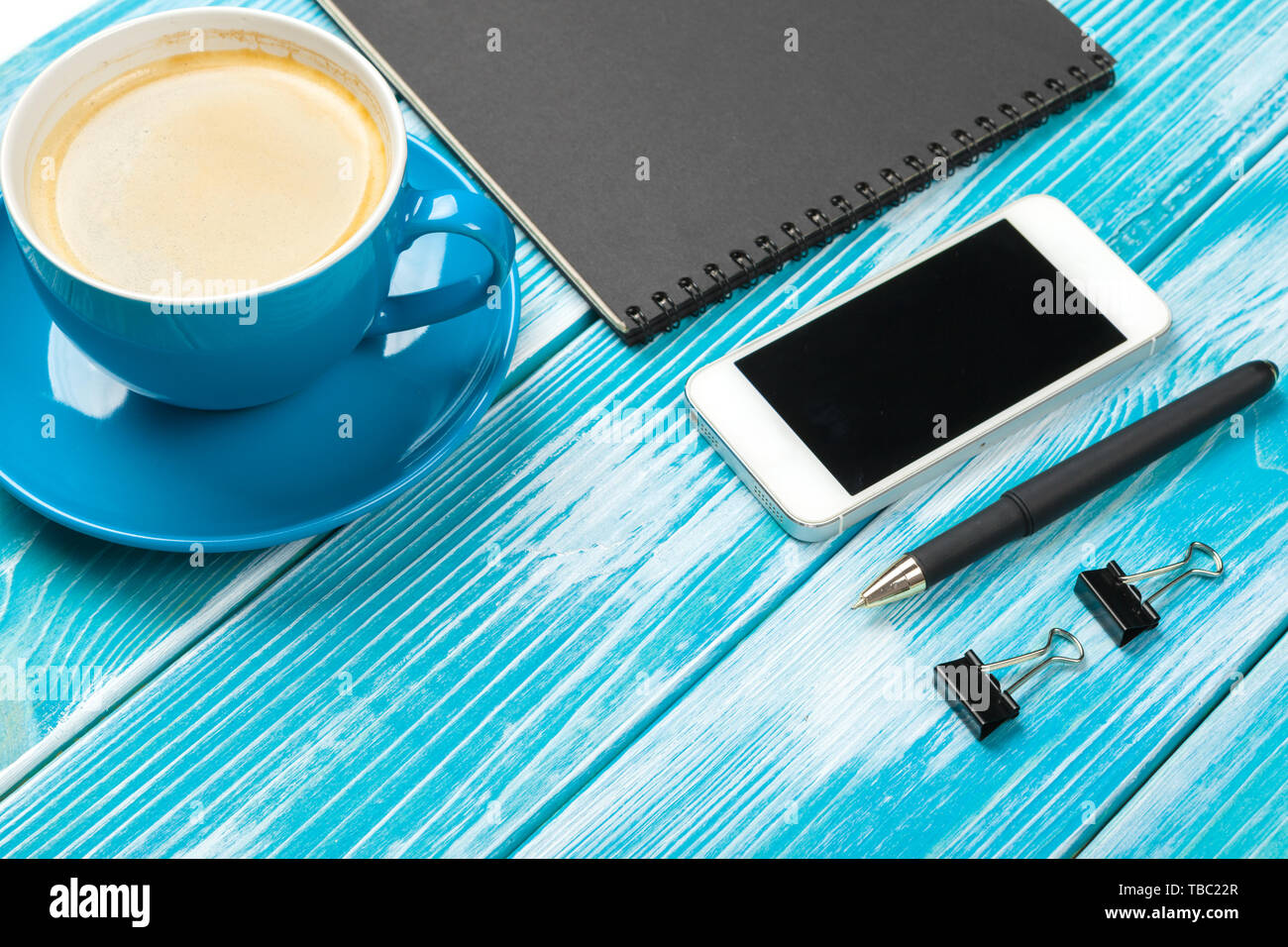 Modern workplace with cup of coffee on wooden table Stock Photo - Alamy