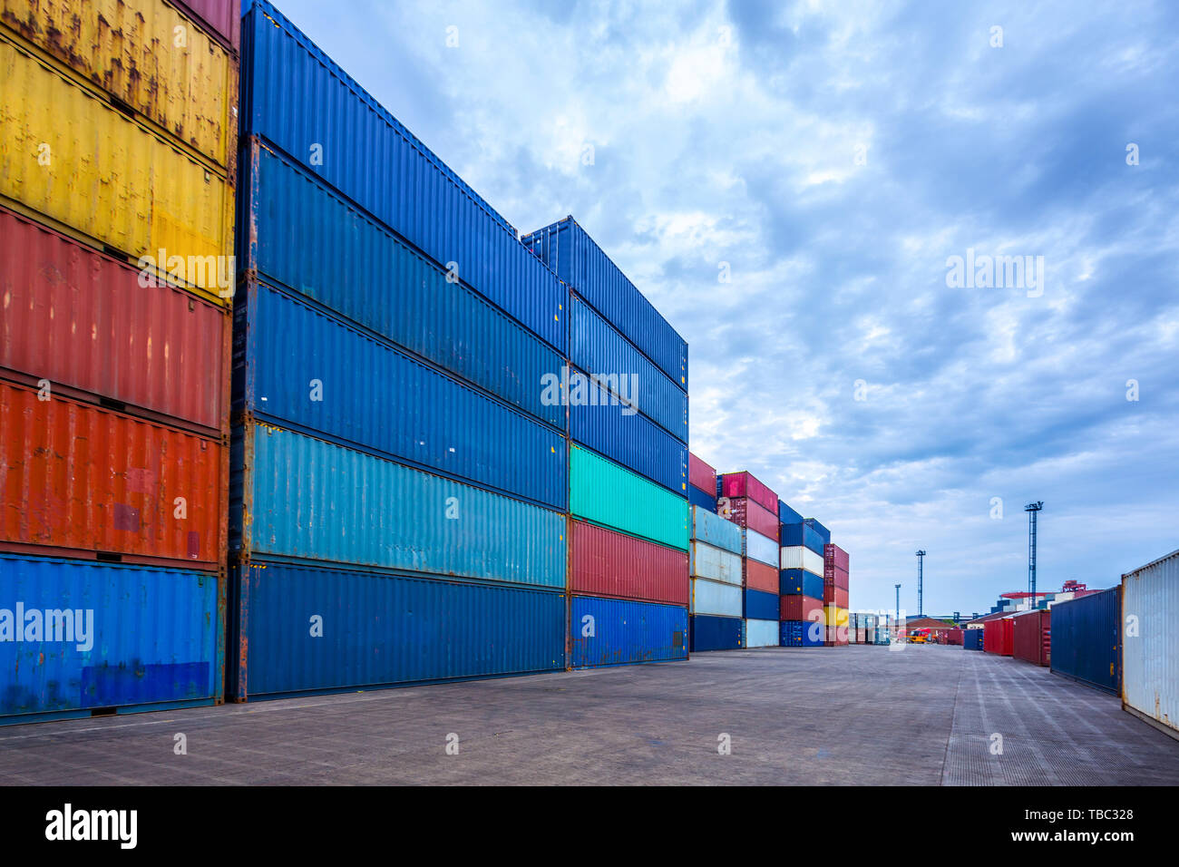 Empty road near stack of containers Stock Photo - Alamy