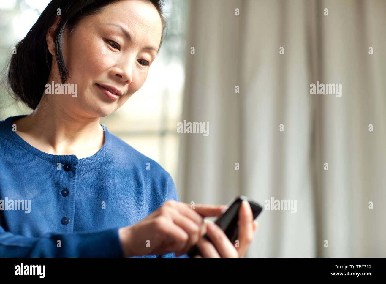 Person over 60 with mobile hi-res stock photography and images - Alamy